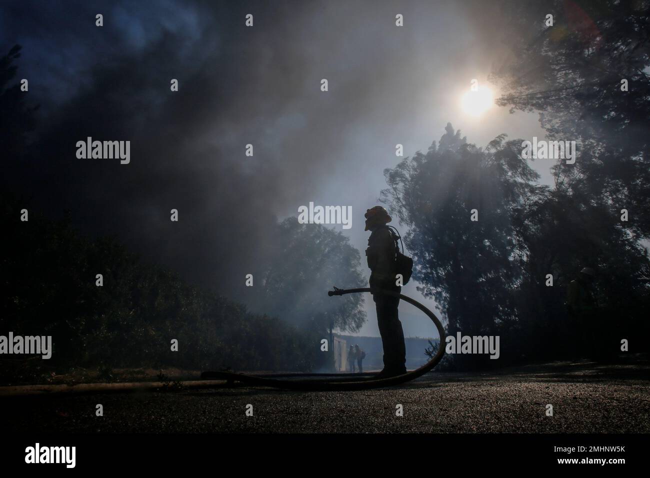 Firefighter Brett Reed battles a wildfire near a ranch in Simi Valley ...