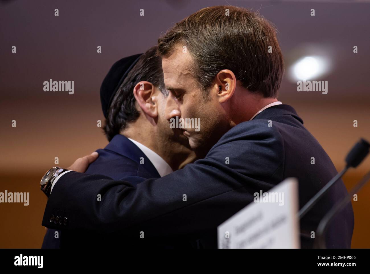 French President Emmanuel Macron, right, hugs Central Jewish Consistory ...