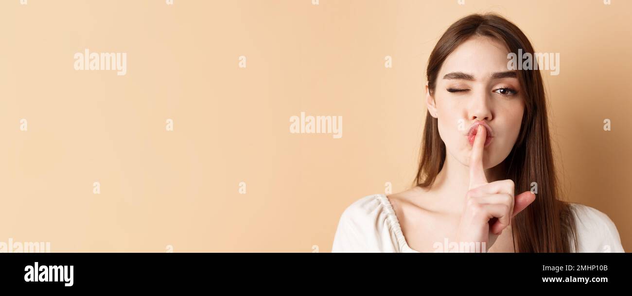 Close Up Of Attractive Woman Shushing At Camera Hiding Secret Making