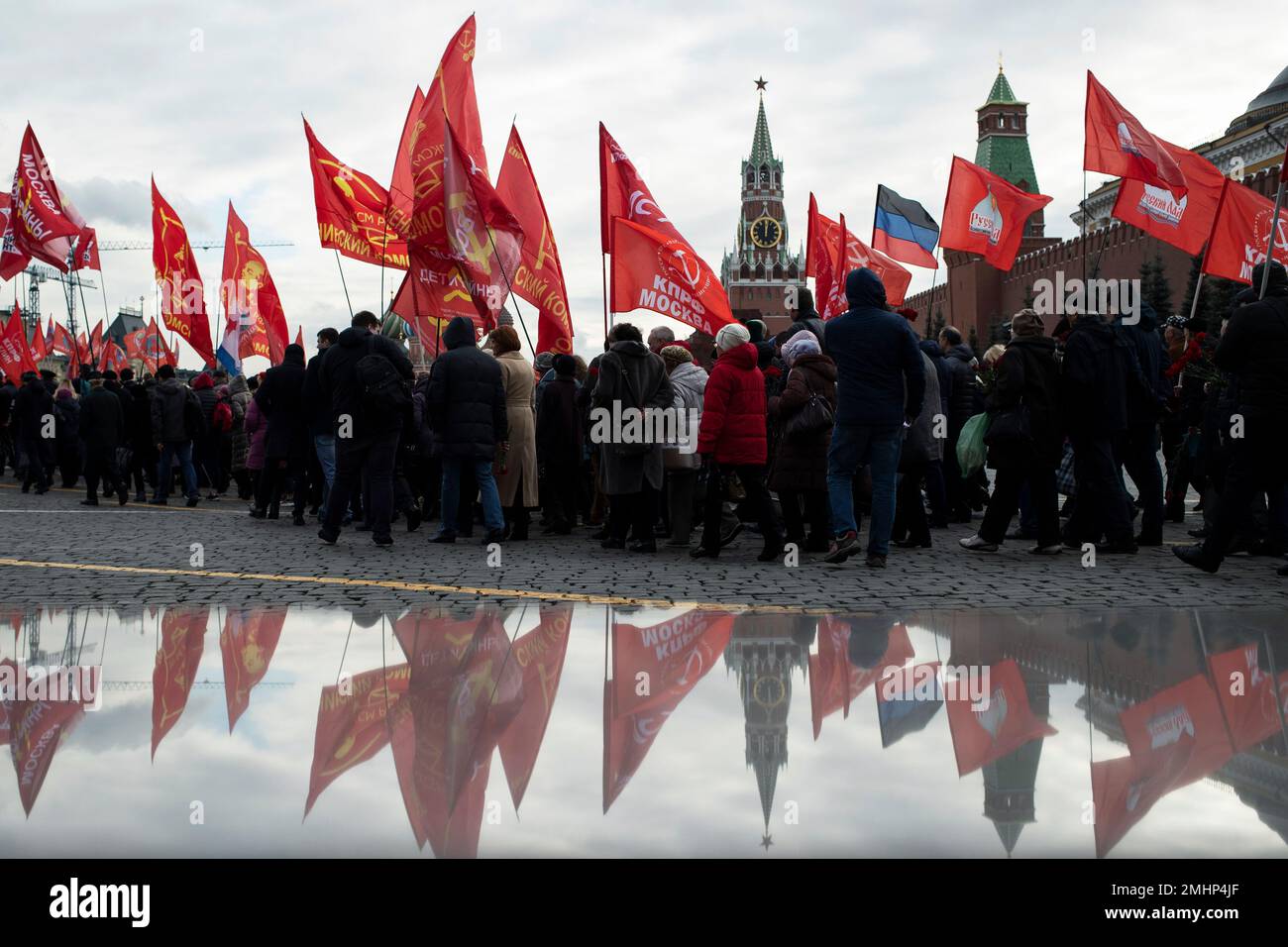 Communist party supporters with red flags walk towards the Tomb of ...