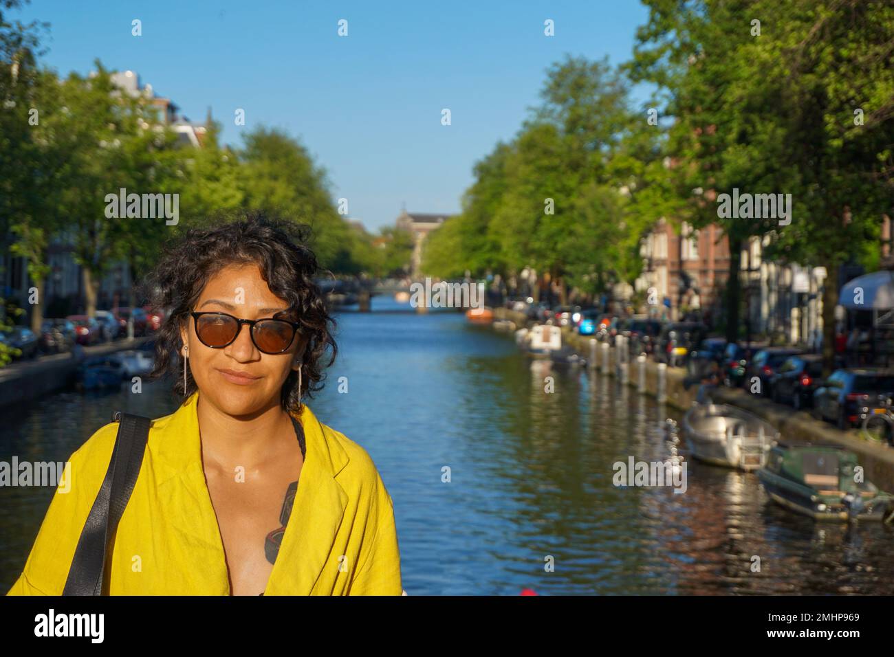 Side view of woman looking through window in city Stock Photo - Alamy