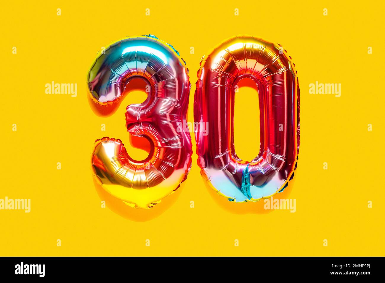 Rainbow foil balloon number, digit thirty. Top view. Colored numeral on ...