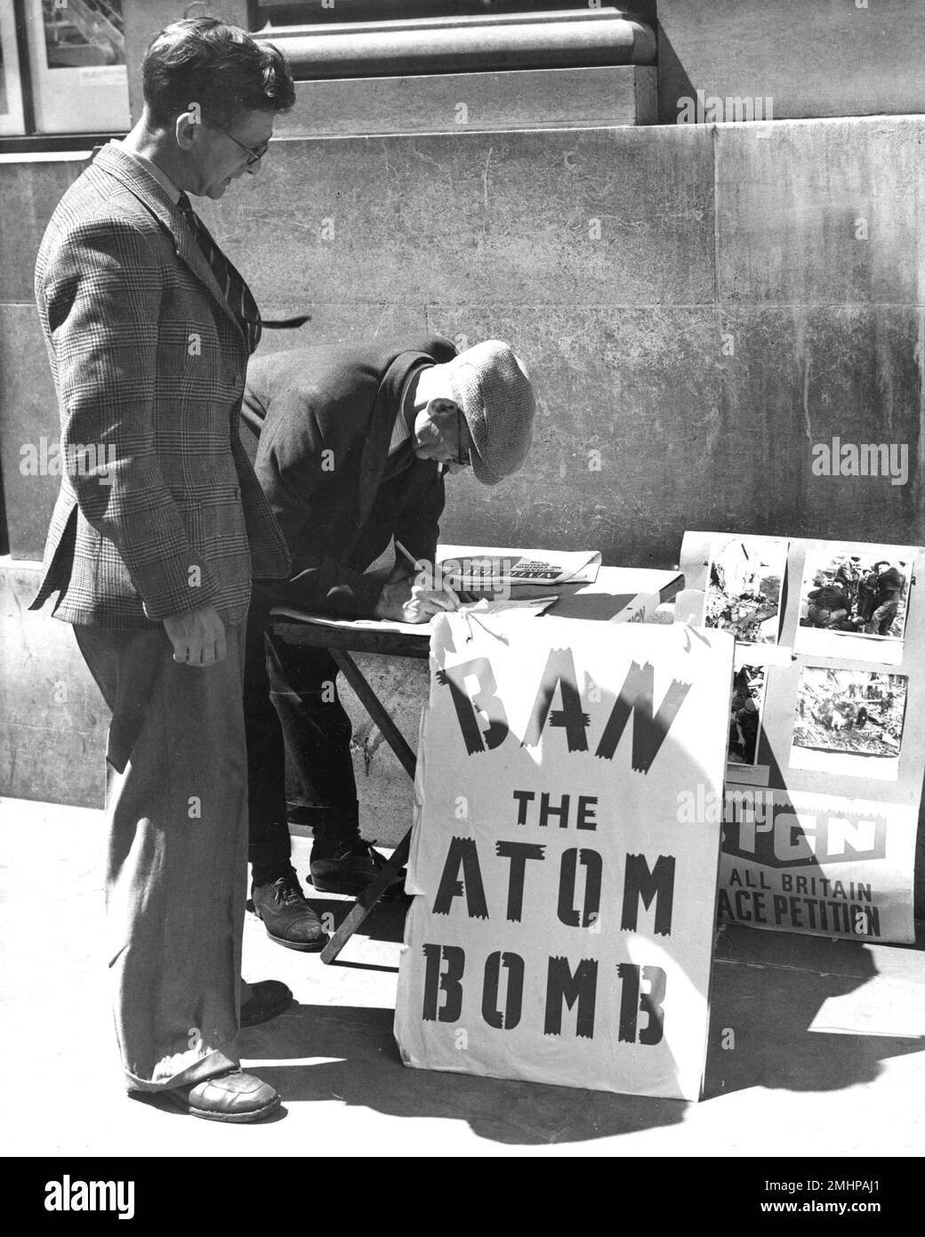 An unidentified man signs the Communist-inspired "All-Britain peace ...
