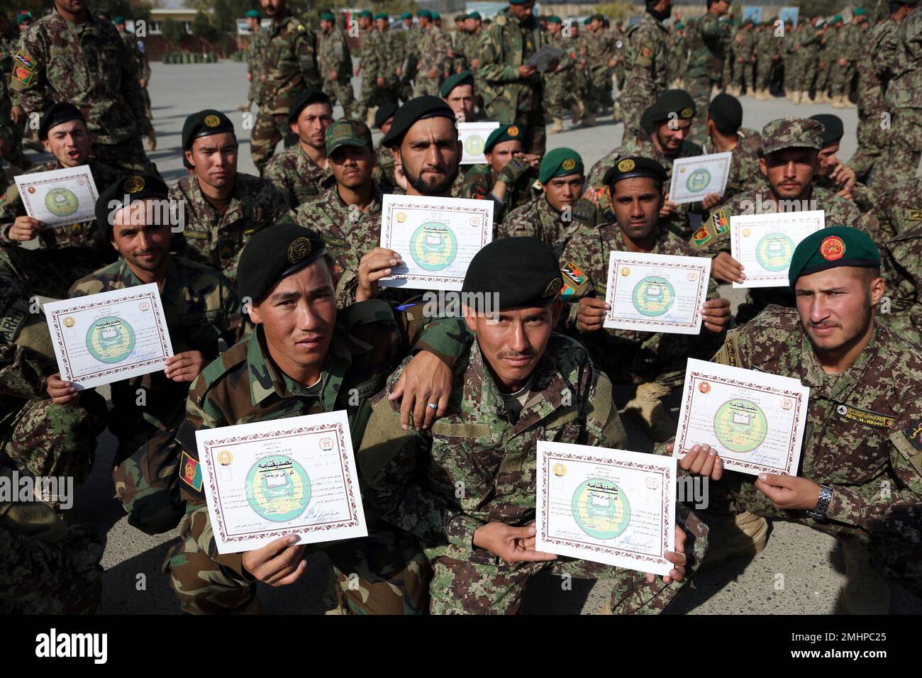 Newly graduated Afghan National Army show their certificate during ...