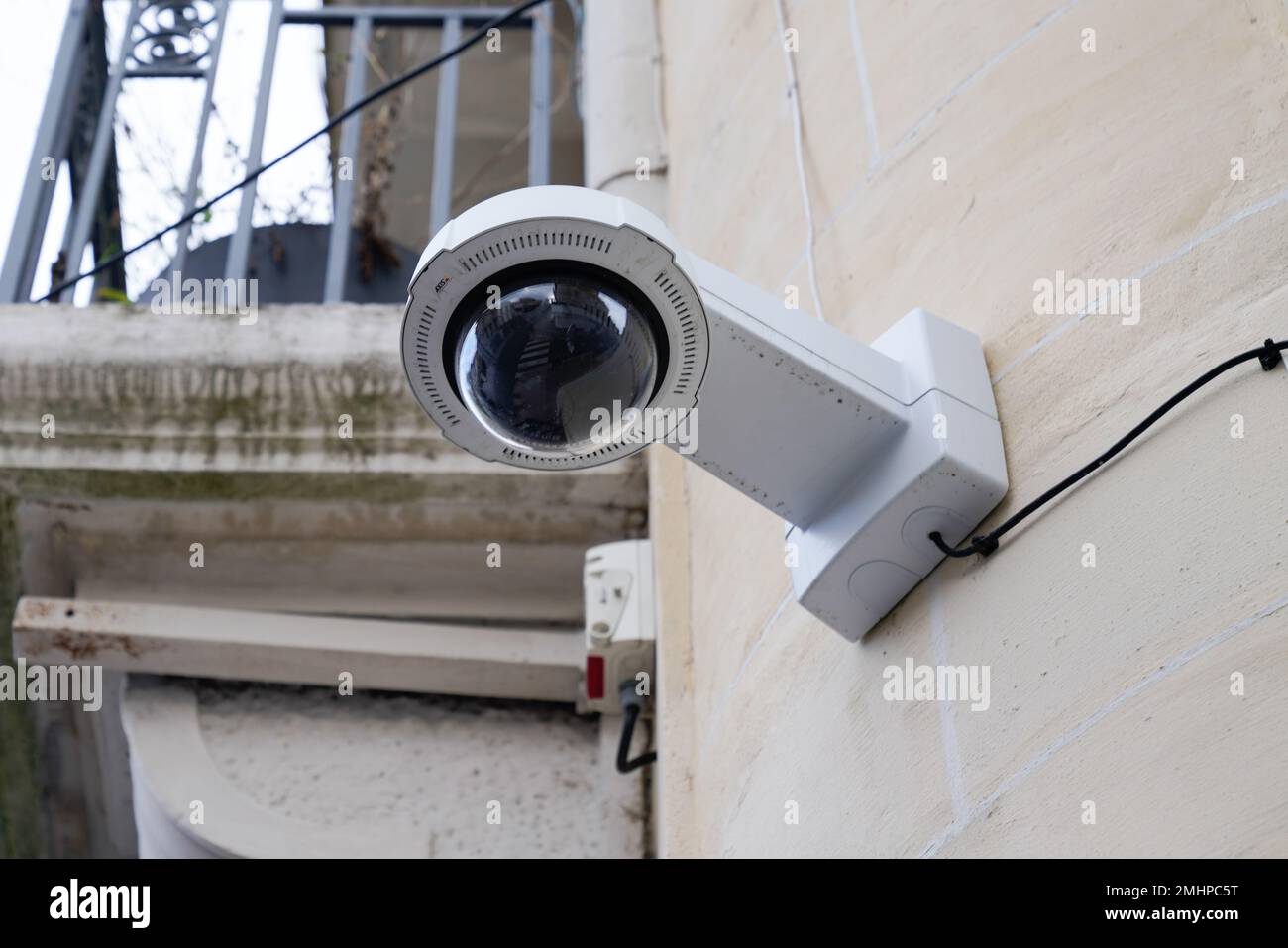 Security round camera on facade wall building Stock Photo - Alamy