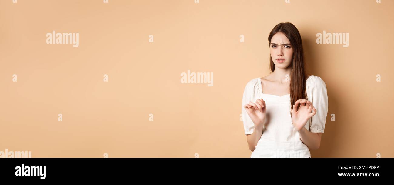 Stay away from me. Disgusted young woman frowning and looking with ...