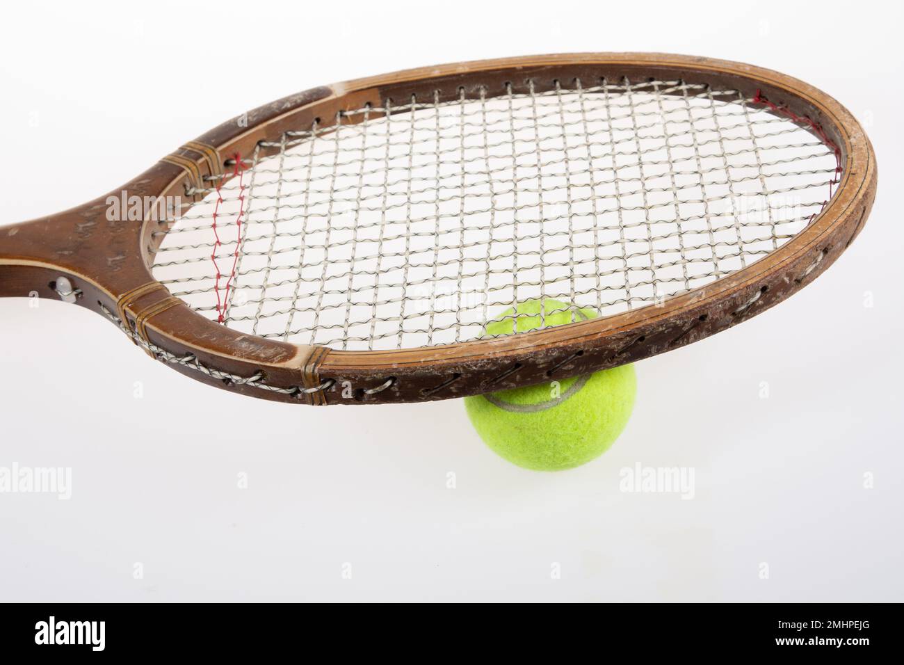 Old ball and wooden tennis racket isolated on grey background Stock ...