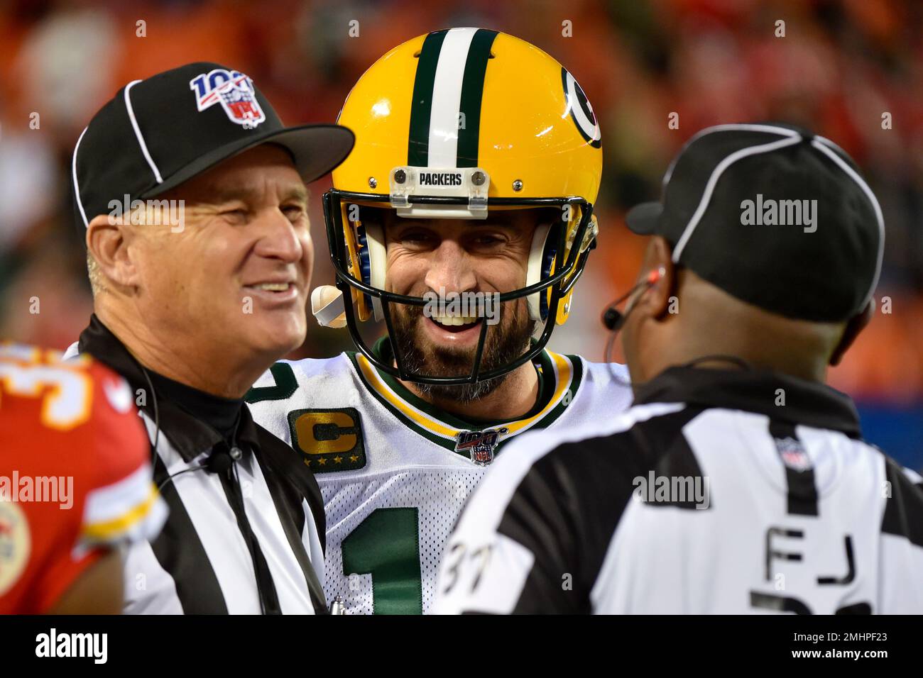 Green Bay Packers quarterback Aaron Rodgers jokes with line judge Mark ...