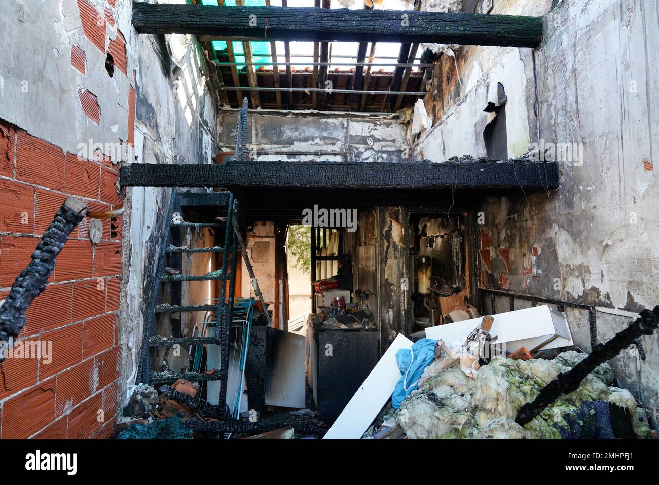 Burnt home room interior with walls house furniture and floor in ash ...
