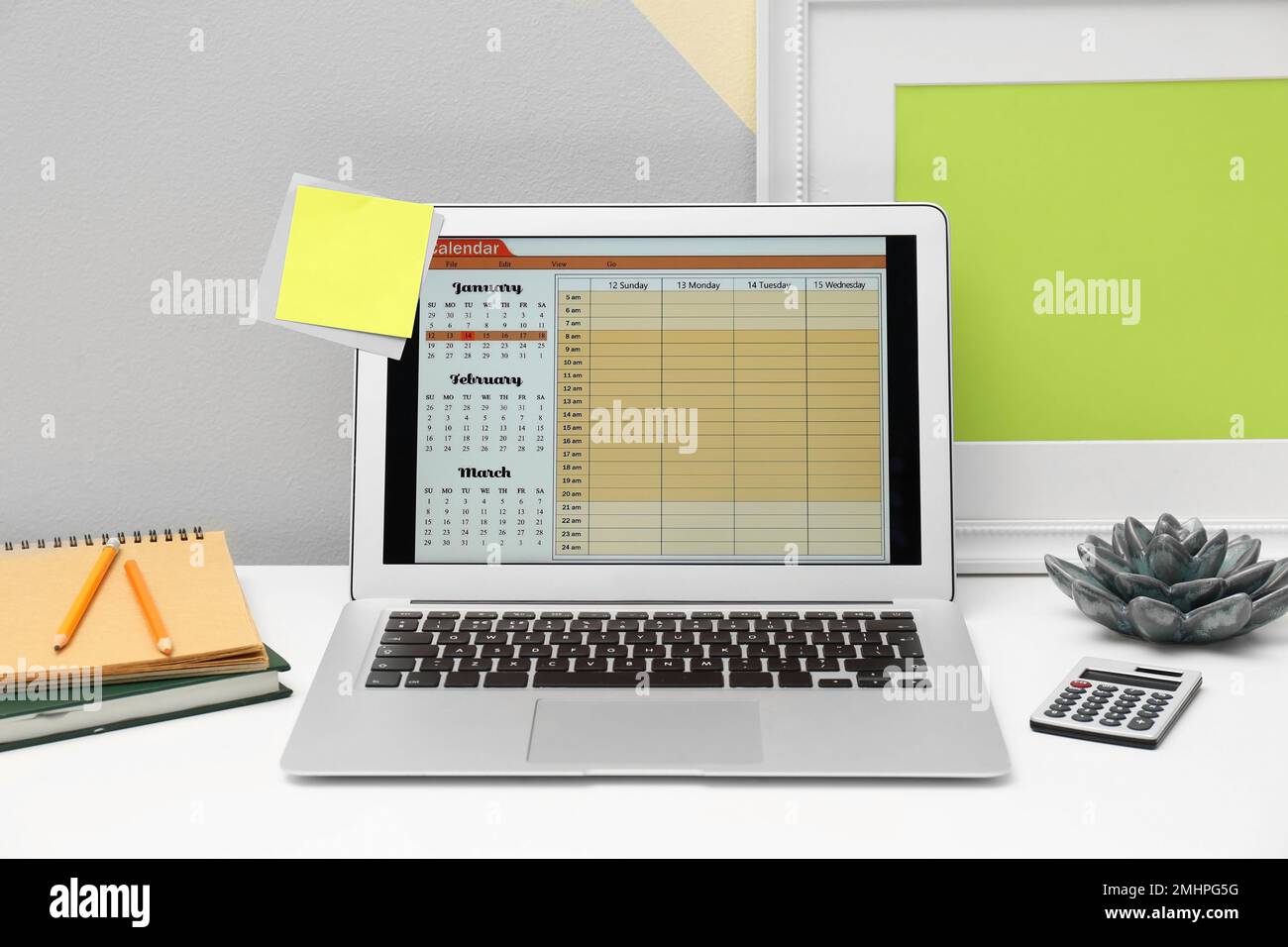 Modern laptop with calendar on screen in office Stock Photo - Alamy