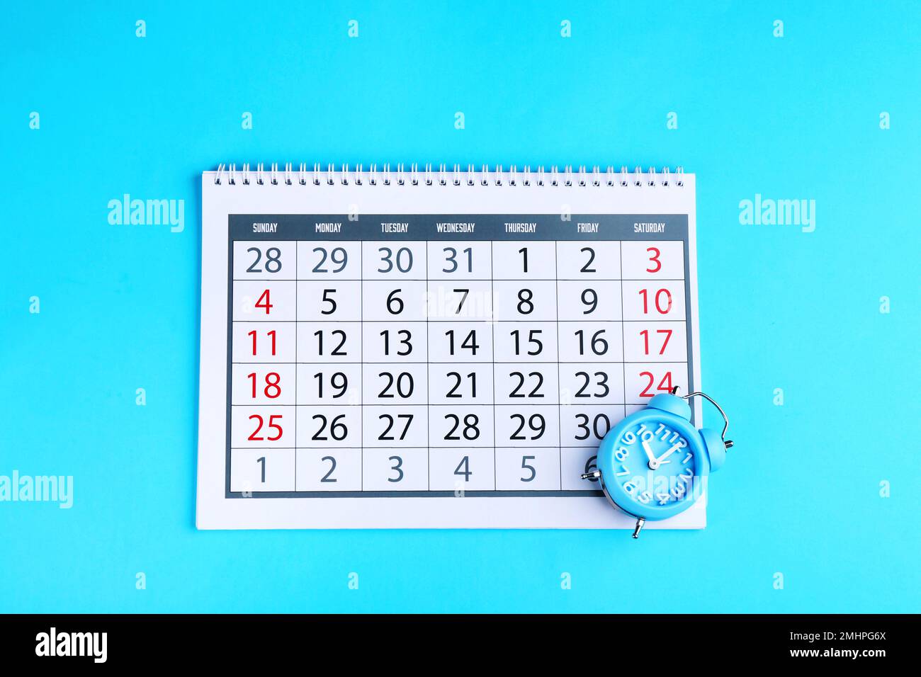 Calendar and alarm clock on light blue background, flat lay Stock Photo ...