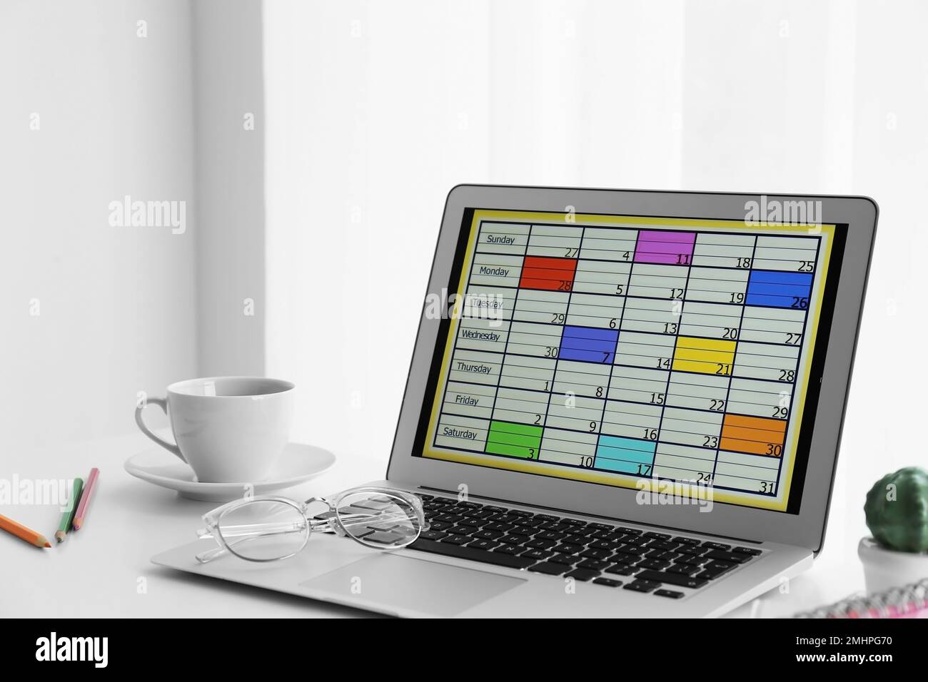 Modern laptop with calendar on screen in office Stock Photo - Alamy