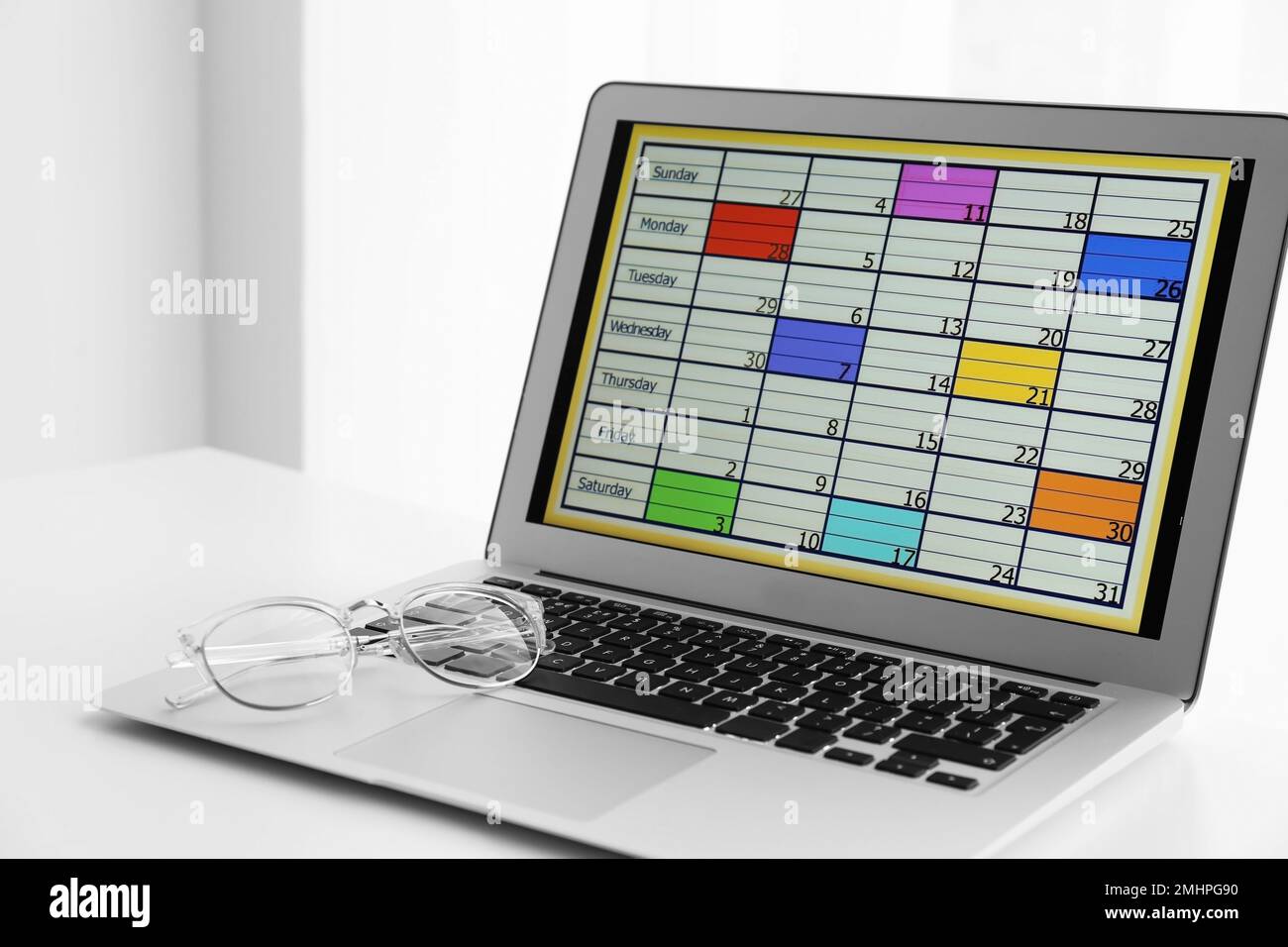 Modern laptop with calendar on screen in office Stock Photo - Alamy
