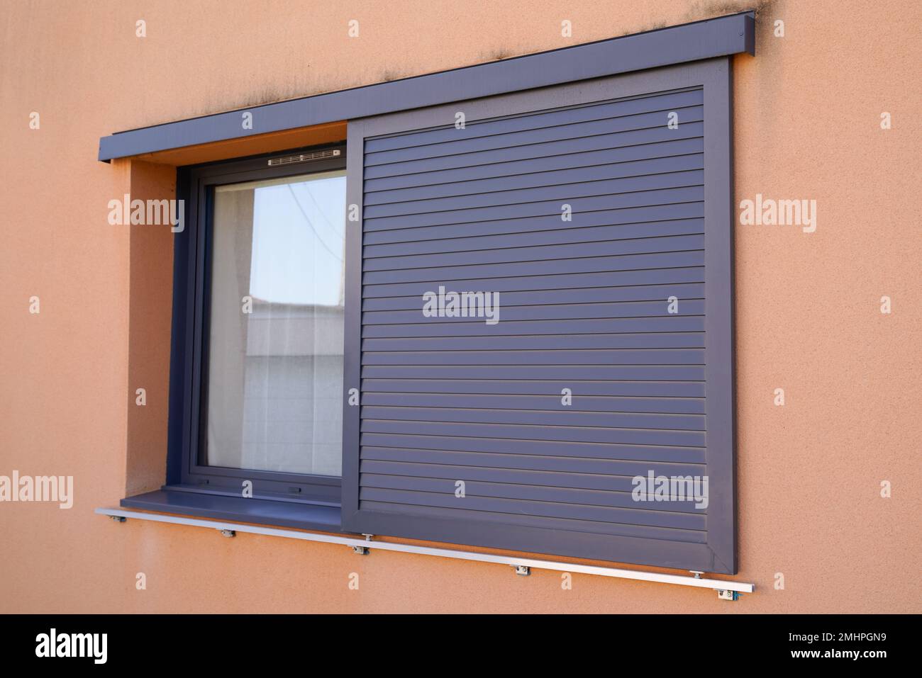 home windows with modern sliding shutters in house facade Stock Photo ...