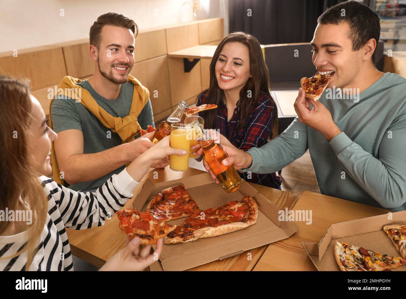 Group of friends having fun party with delicious pizza in cafe Stock ...
