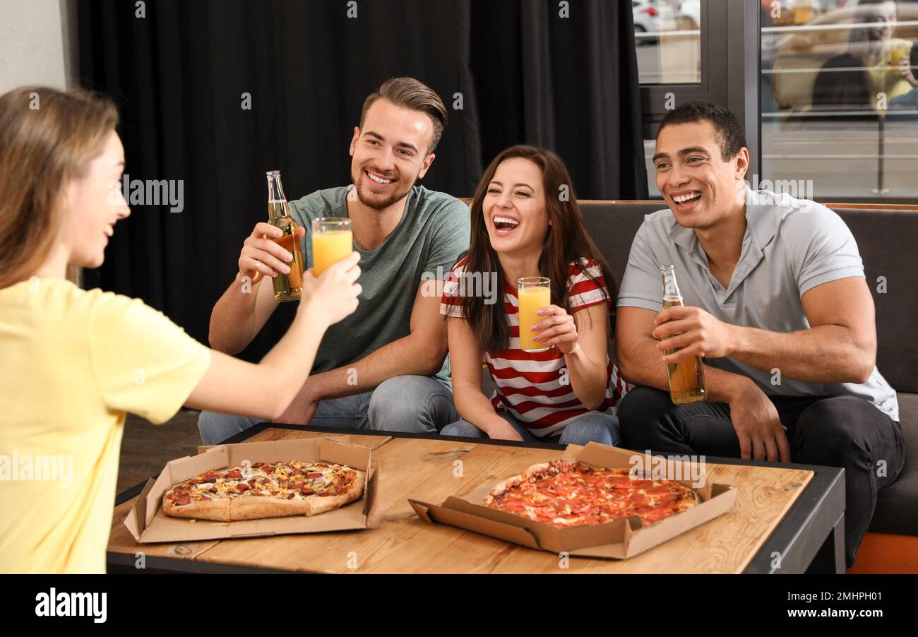 Group of friends having fun party with delicious pizza in cafe Stock ...