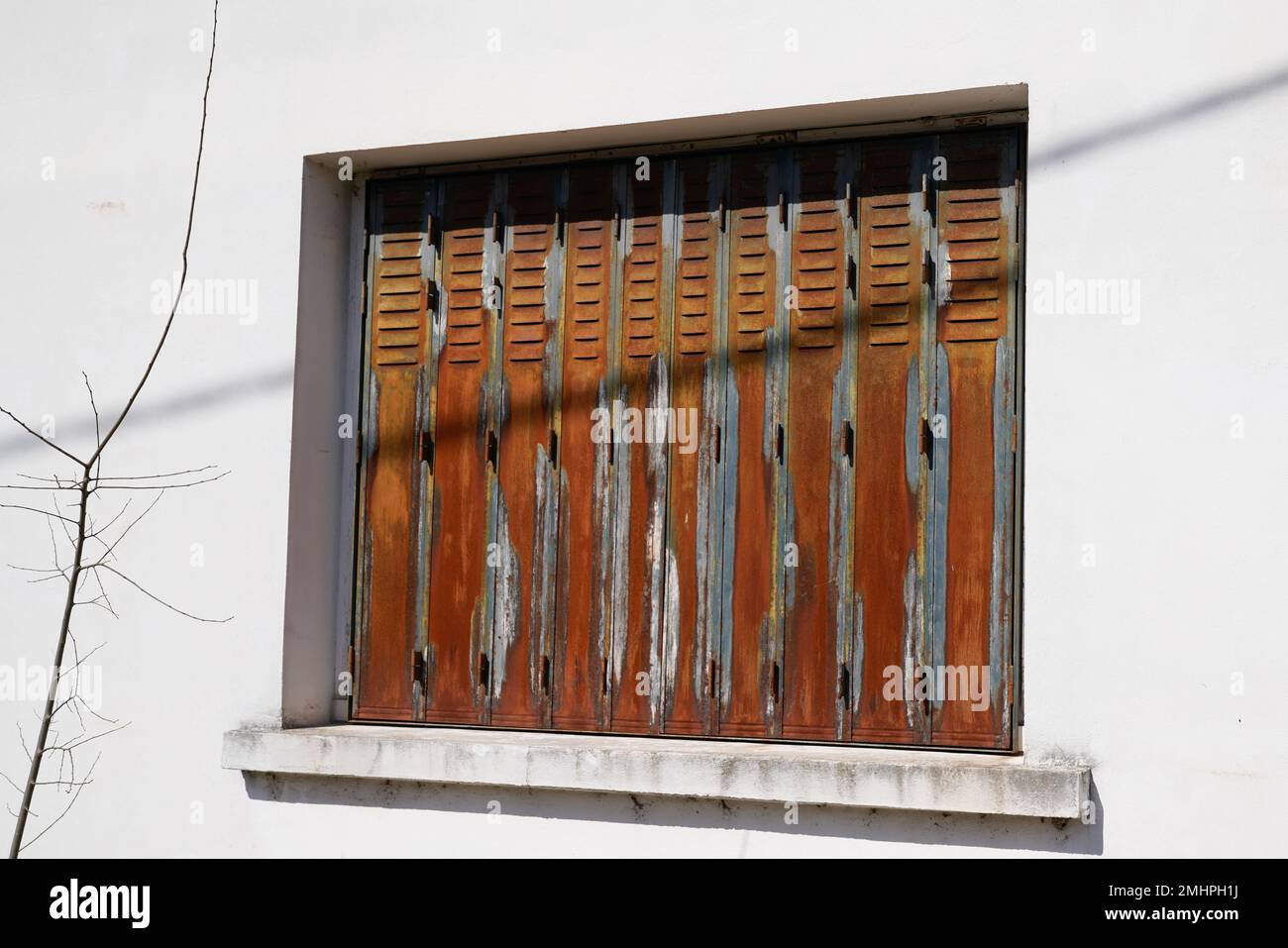 rusty old house window shutters over white wall home on the facade ...