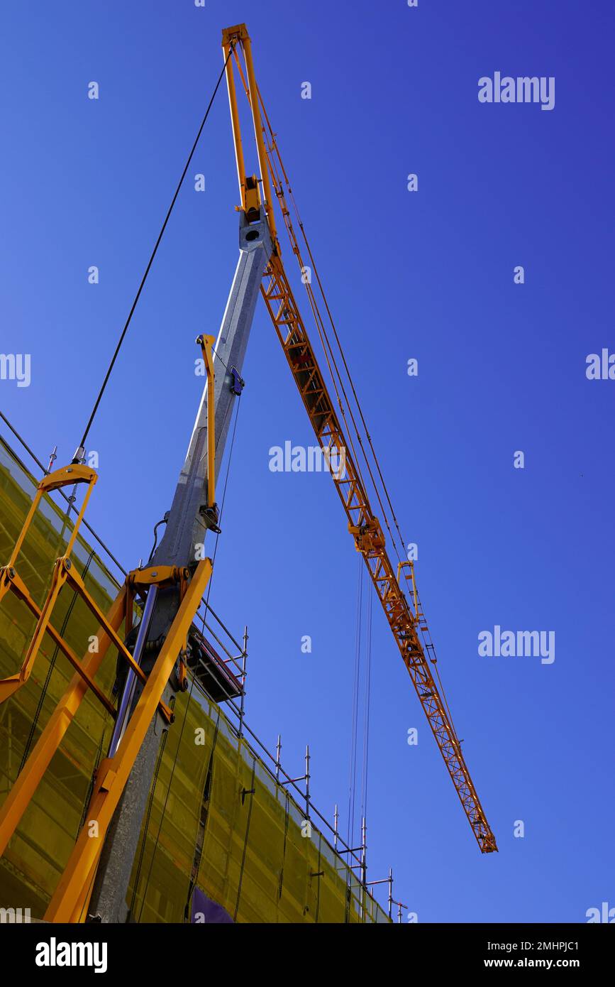 yellow crane on a building construction site architectural landscape ...