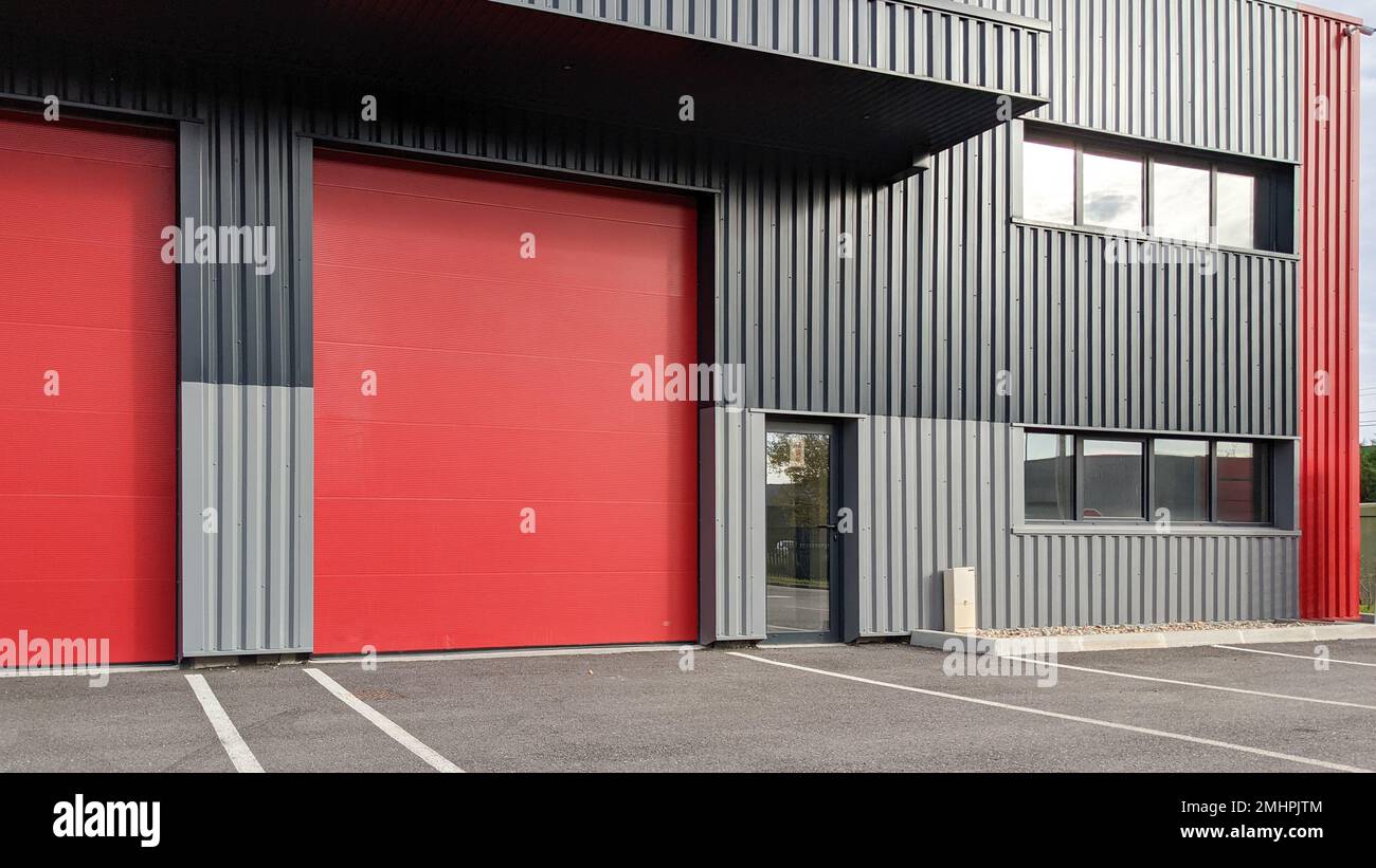 modern industrial unit with two red roller doors Stock Photo - Alamy