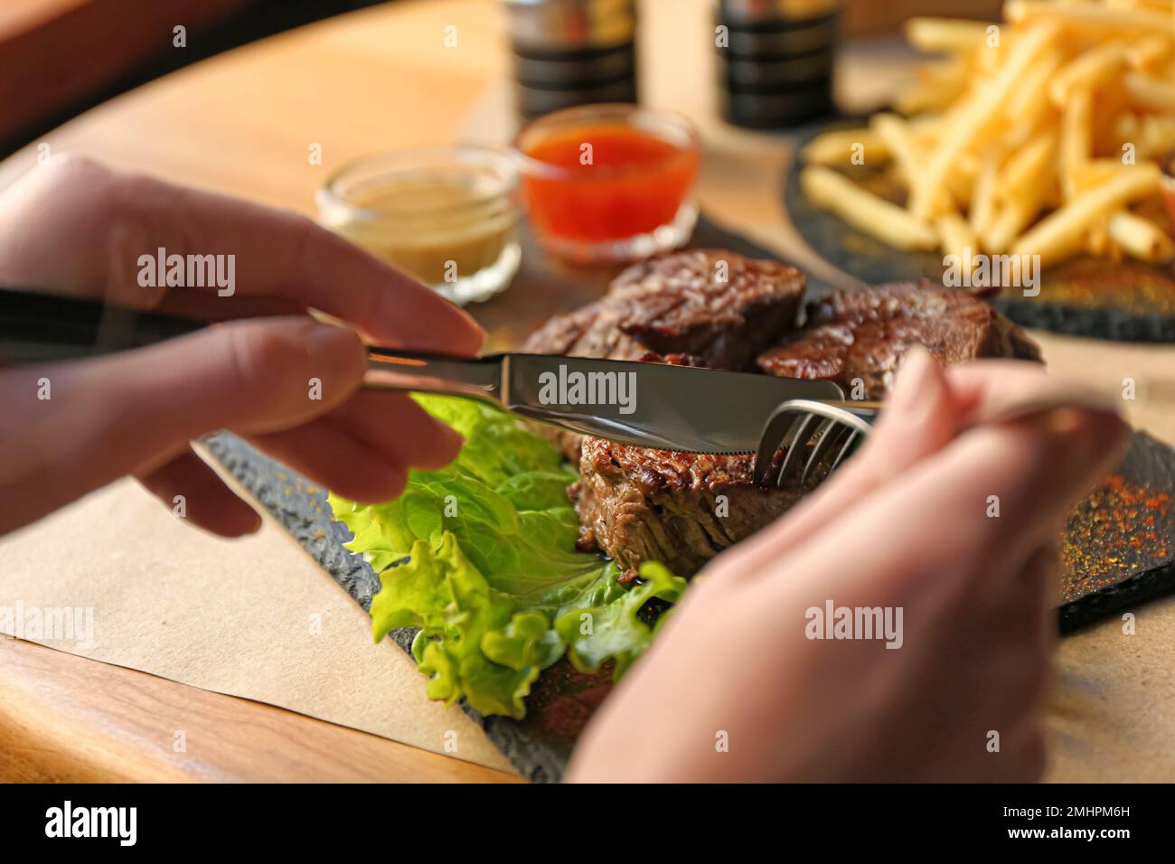 Woman eating tasty shish kebab in cafe Stock Photo - Alamy