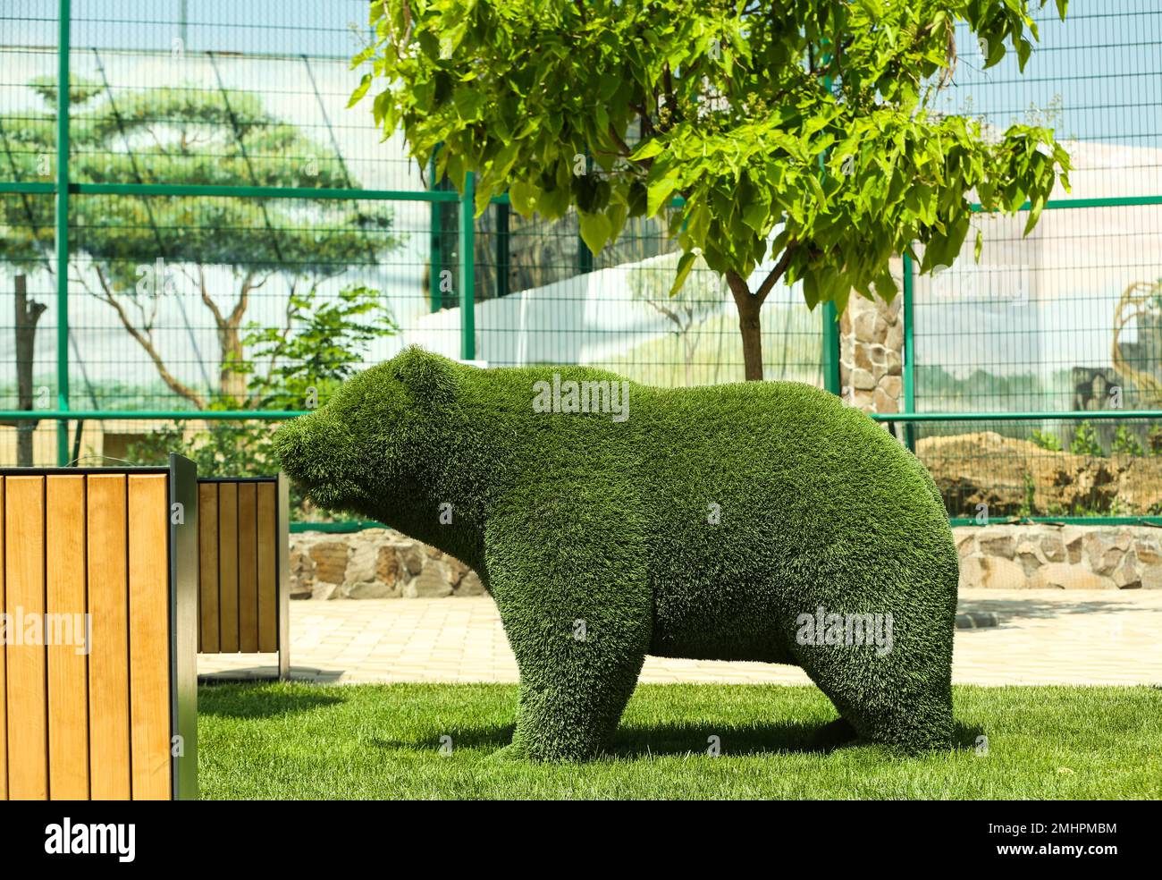 Beautiful bear shaped topiary at zoo on sunny day. Landscape gardening ...