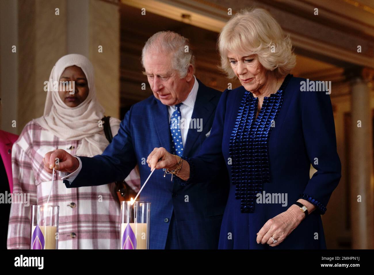 King Charles III and the Queen Consort light a candle at Buckingham ...