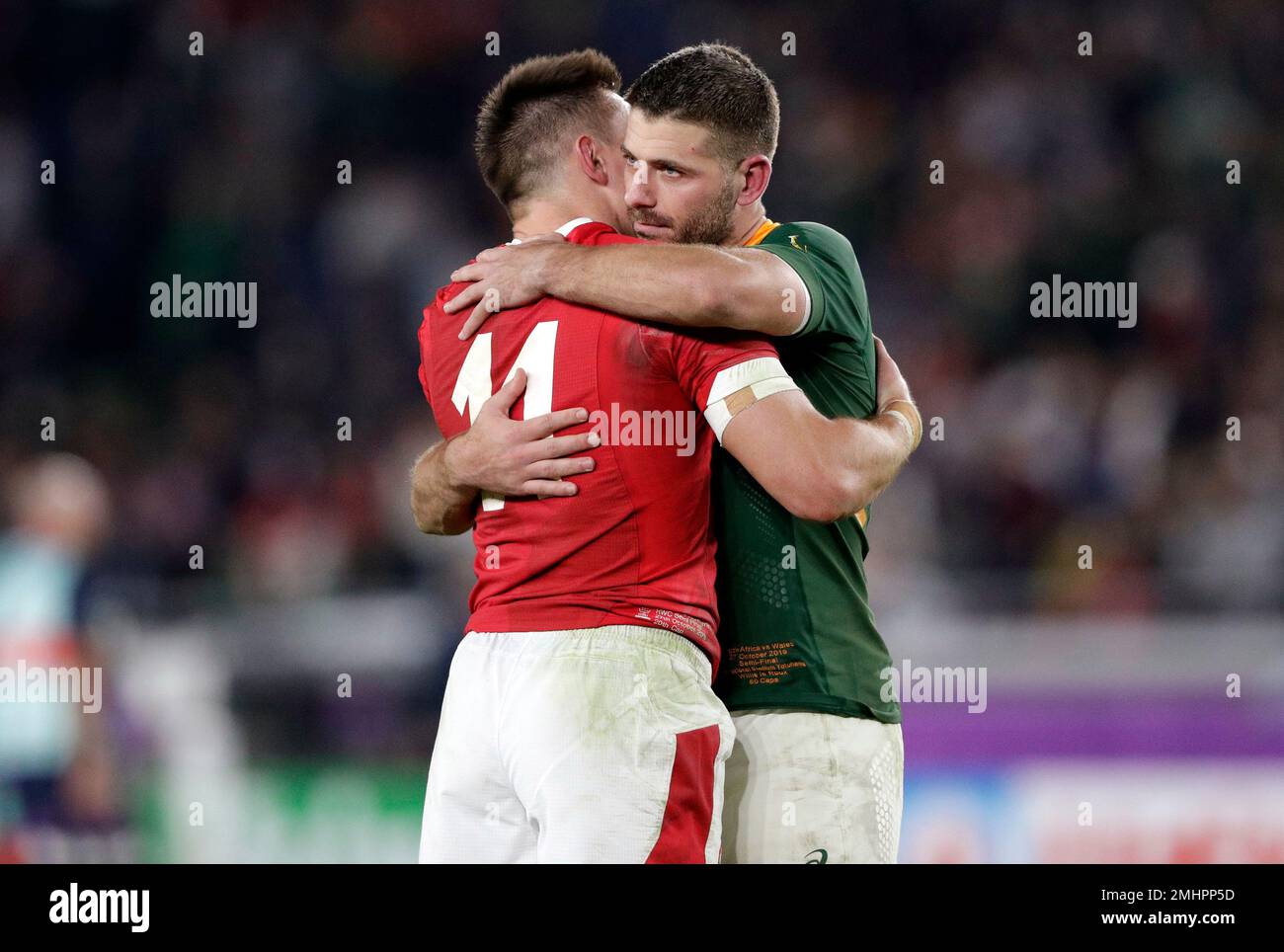 South Africa's Handre Pollard, right, hugs Wales' Josh Adams following ...