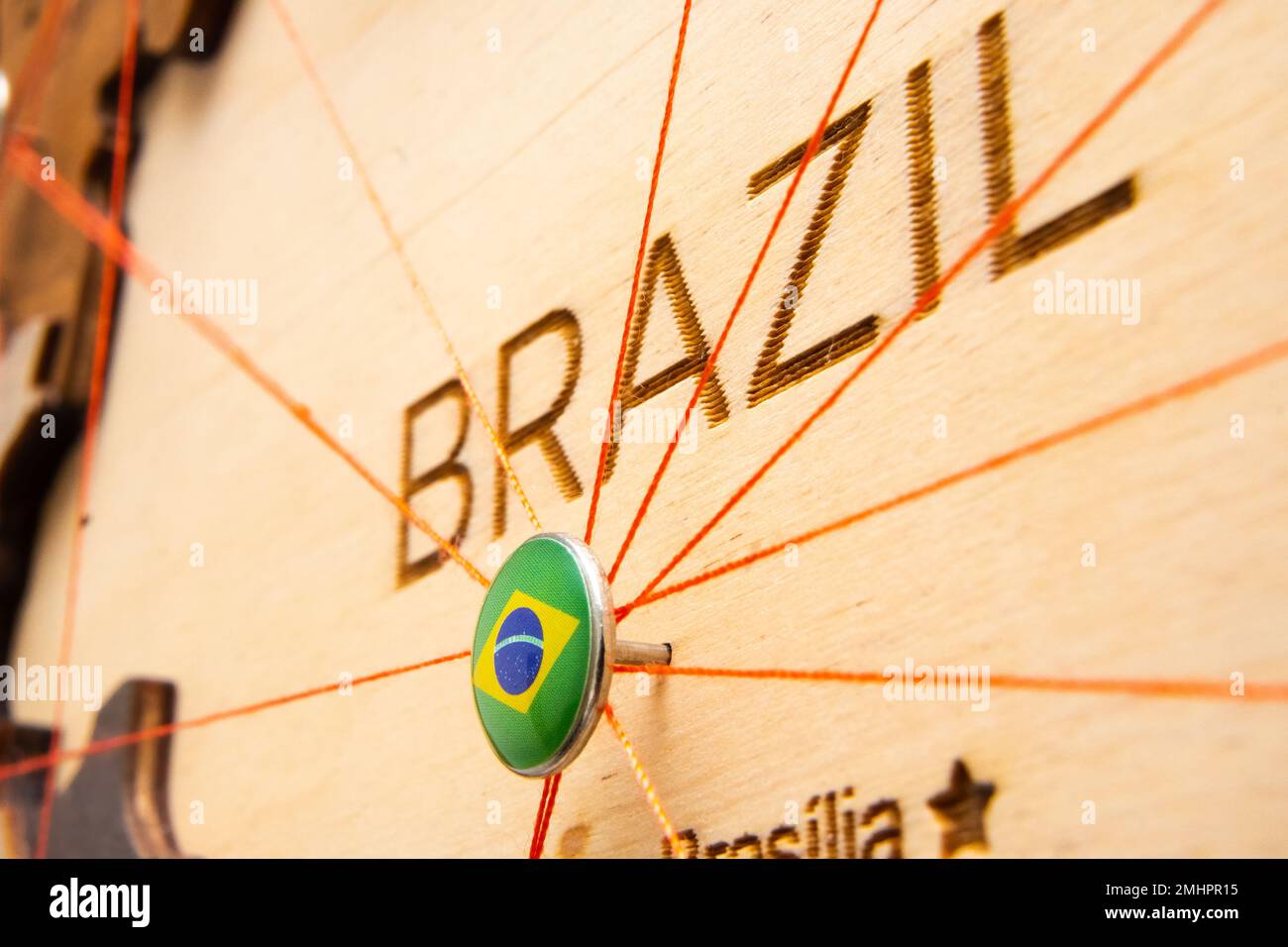 Brazil flag on the pushpin with red thread showed the paths of movement ...