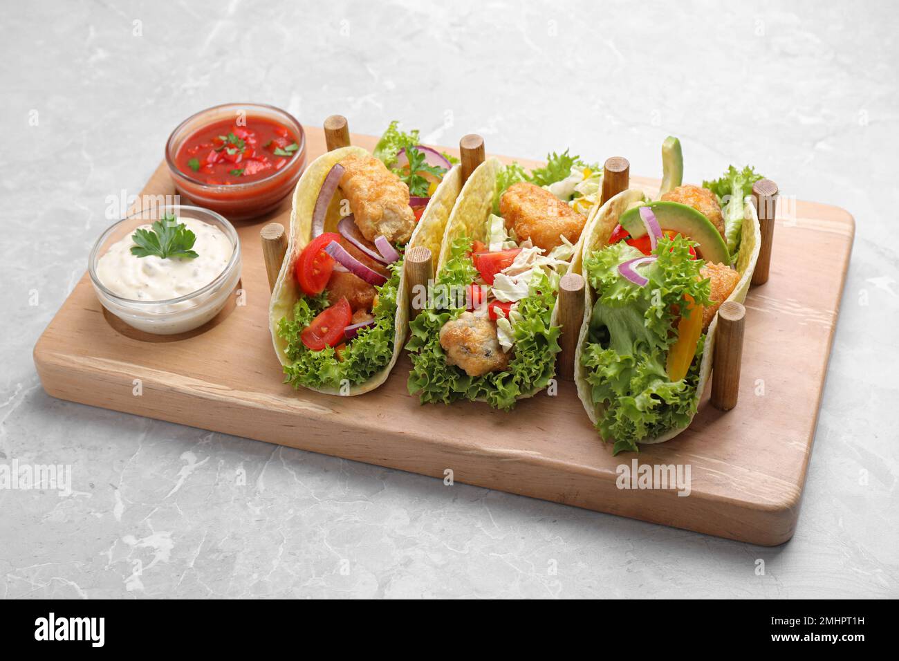 Delicious fish tacos served on grey marble table Stock Photo - Alamy