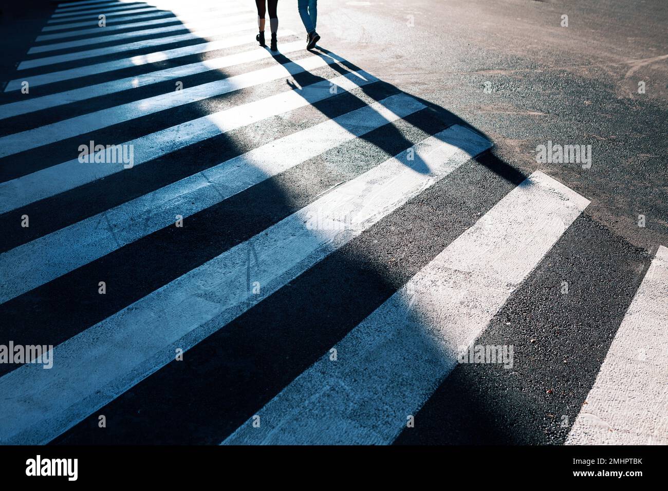 People Crossing City Street . Shadow on Urban Crosswalk Stock Photo - Alamy