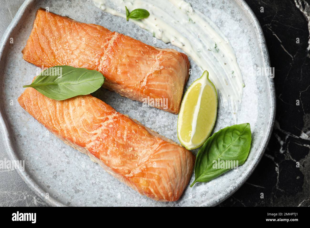 Tasty cooked red fish on dark grey marble table, top view Stock Photo ...