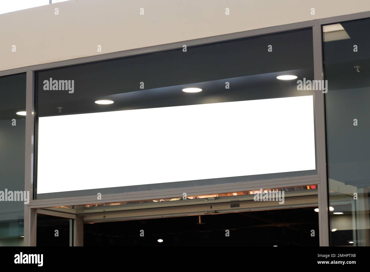 Mock up of empty rectangle white logo sign in front of facade shop wall ...