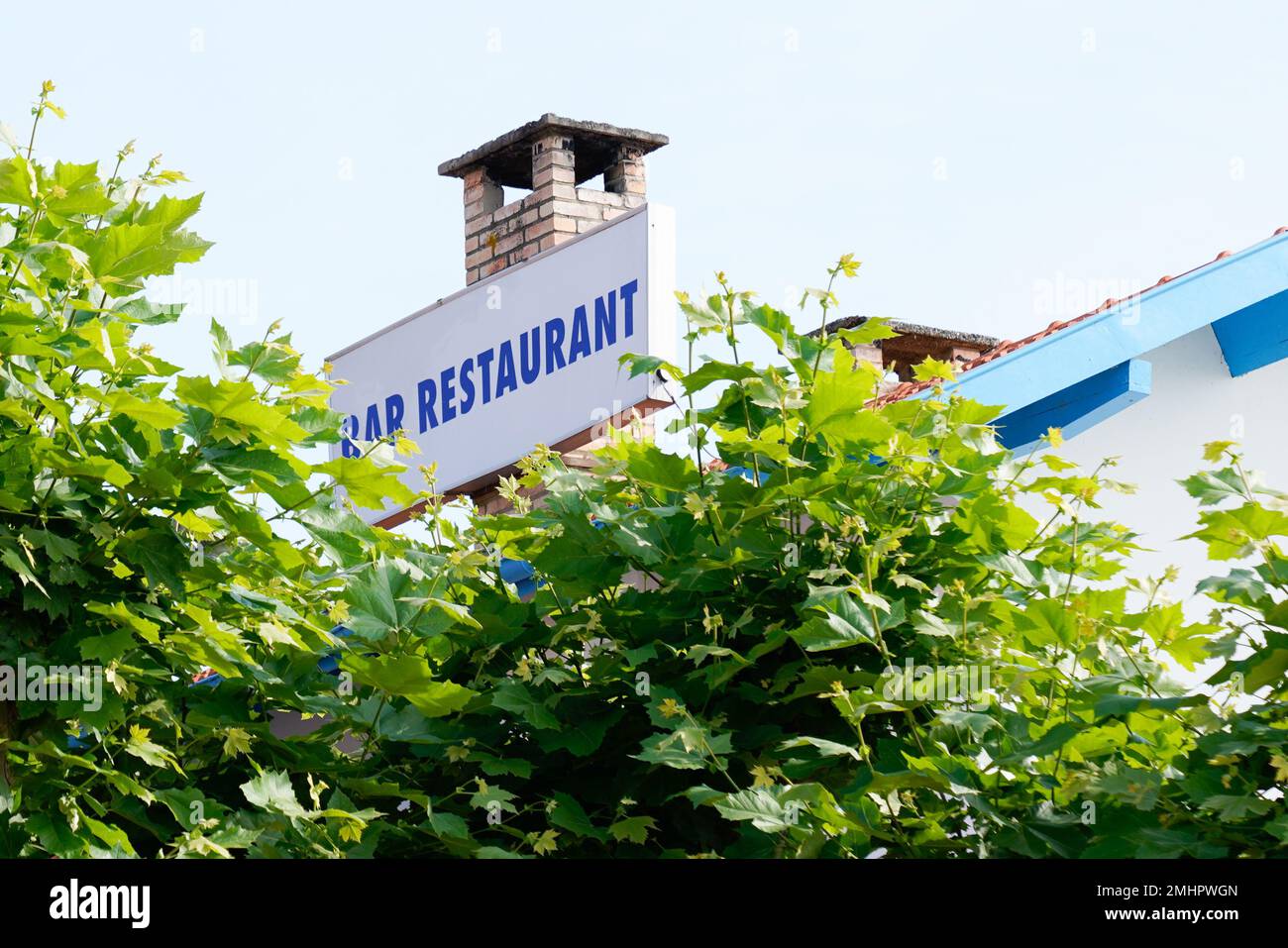 bar restaurant sign on roof urban facade building Stock Photo - Alamy