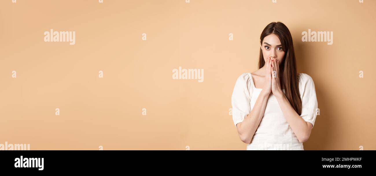 Omg shocking. Speechless woman covering mouth with hands and staring ...