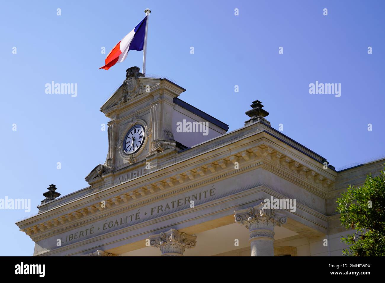 French tricolor flag on city hall in town center in france Stock Photo ...