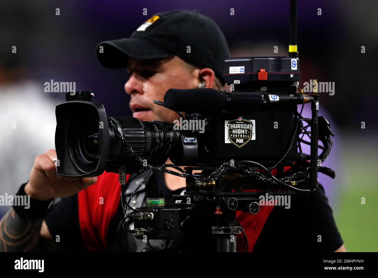 A Fox television steadicam operator work during an NFL football game ...