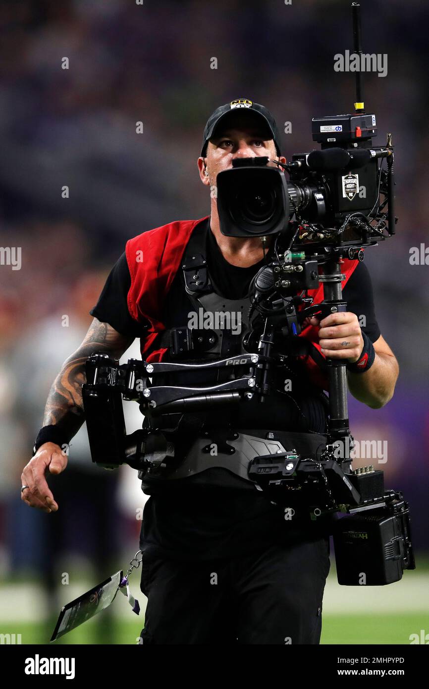 A Fox television steadicam operator work during an NFL football game ...