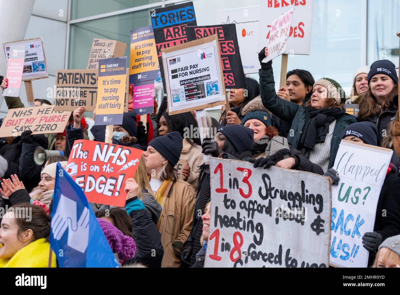 Striking nurses with placards, demonstrating outside University College ...