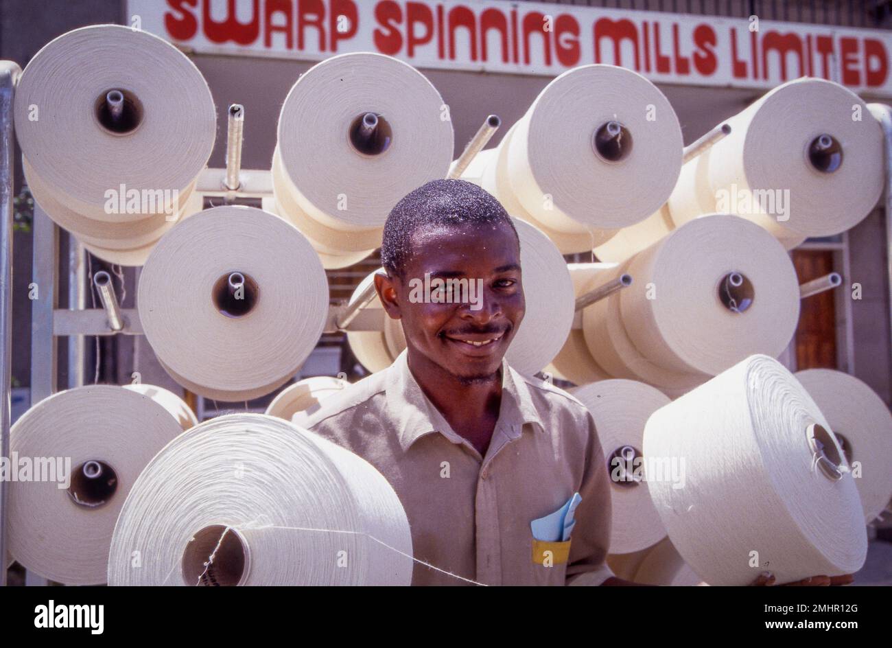 Zambia, Ndola, labourer of Swarp Spinning Mills with spindles of cotton ...