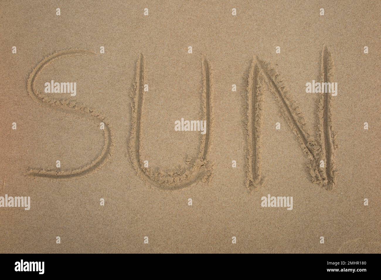 The Word Sun Written in the Sand on a Beach Stock Photo - Alamy