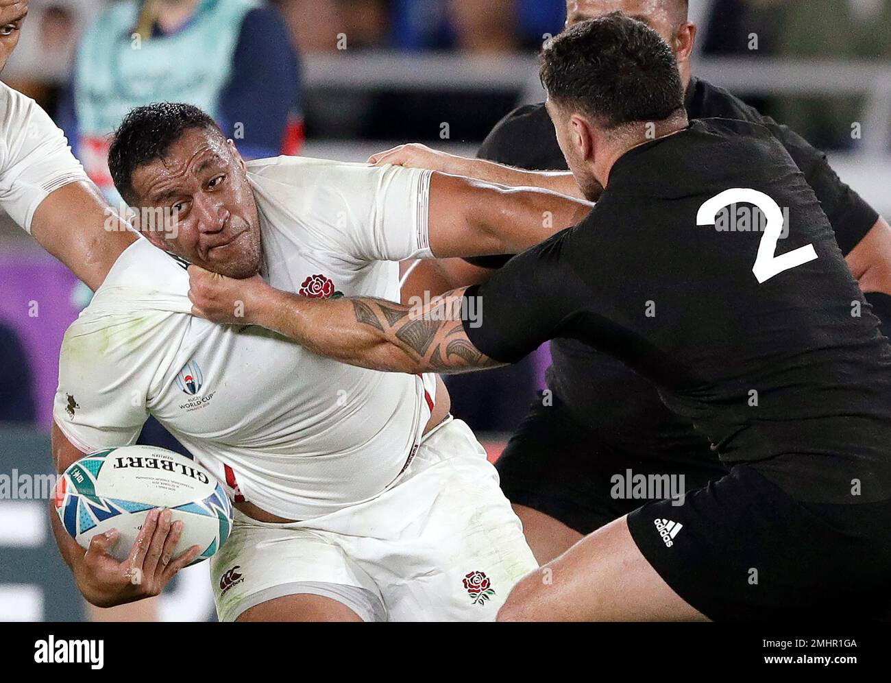 England's Mako Vunipola, left, is grabbed by the scruff of the neck by ...