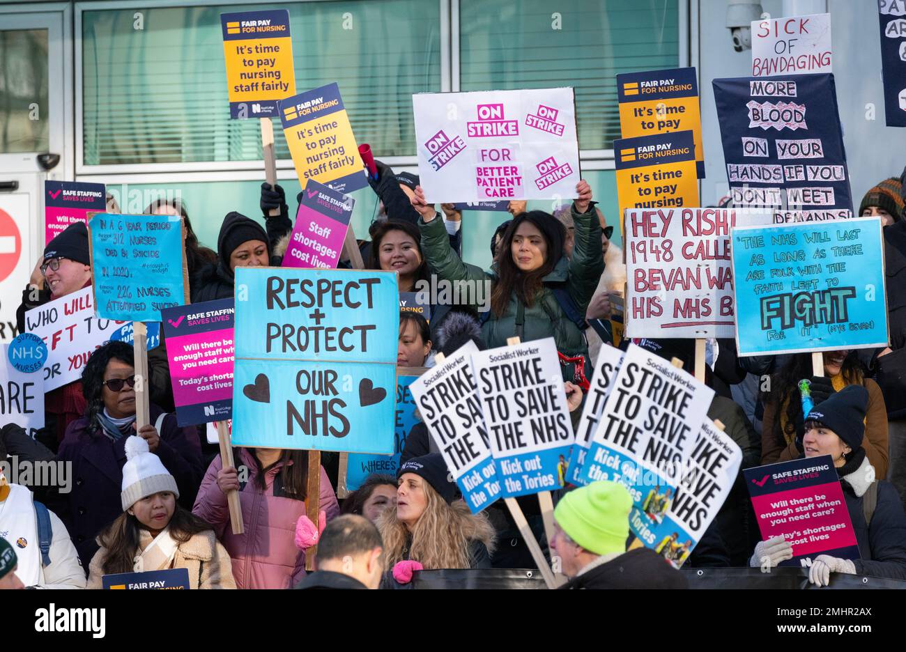 Striking nurses with placards, demonstrating outside University College ...