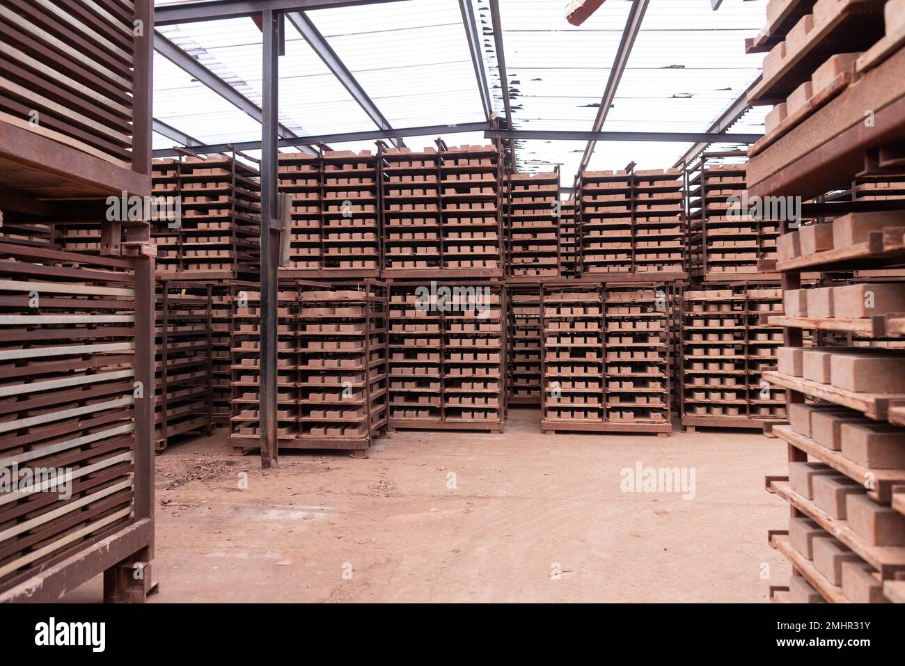 A warehouse filled with piles of lumber and other materials Stock Photo ...