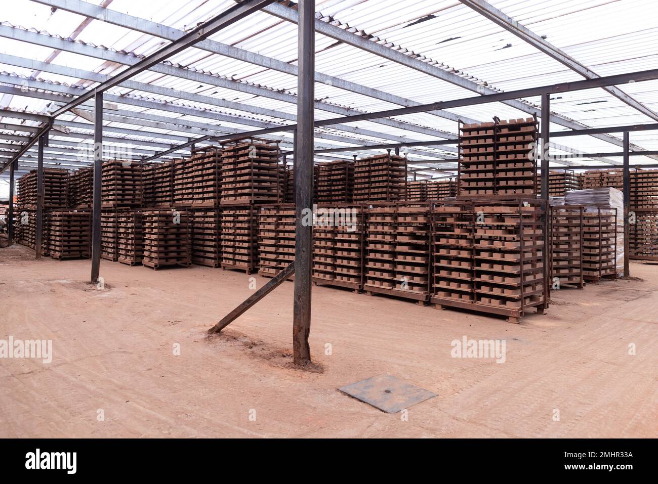 A warehouse filled with piles of lumber and other materials Stock Photo ...