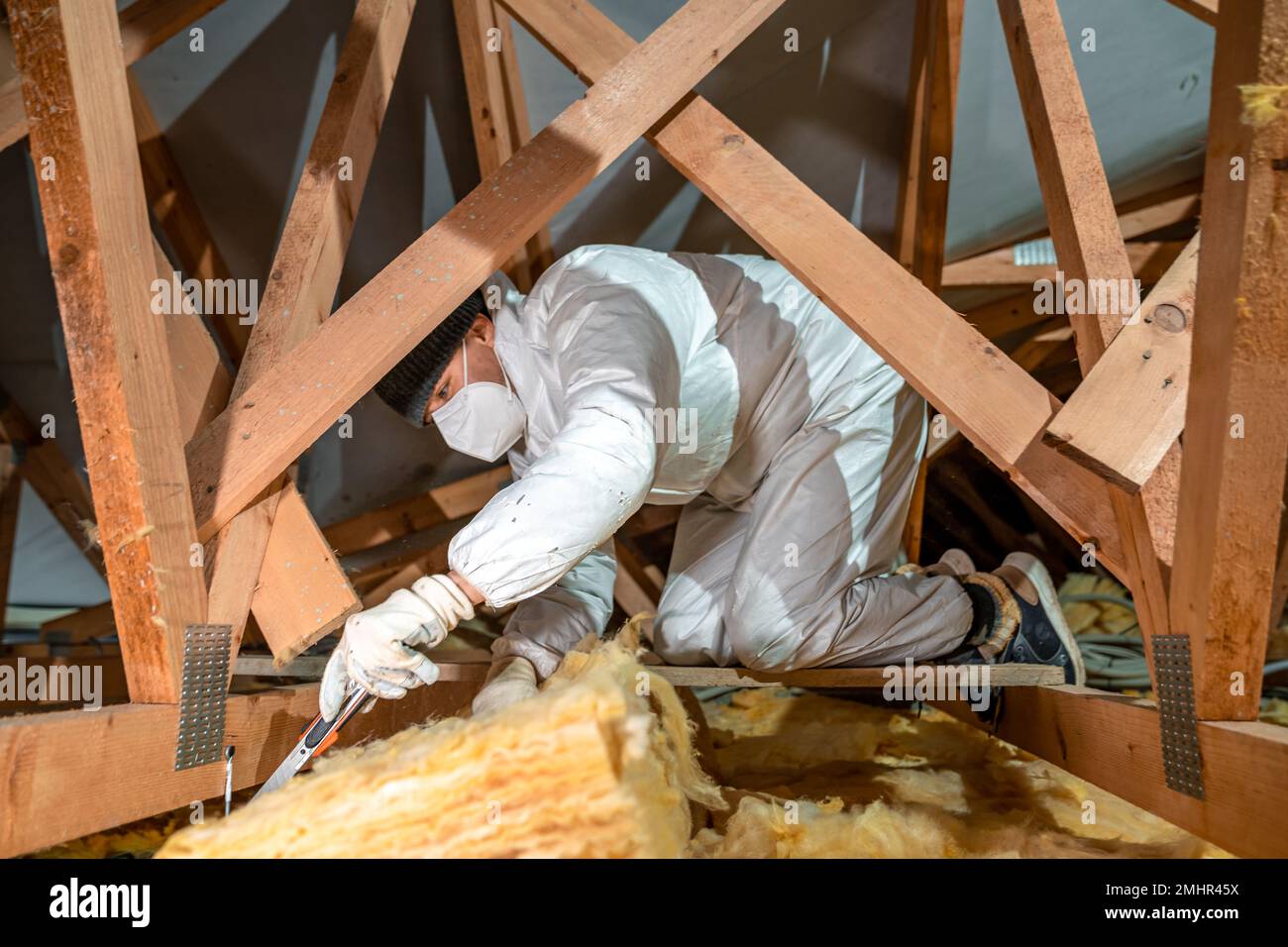 cutting of glass wool for the insulation of rooms Stock Photo - Alamy