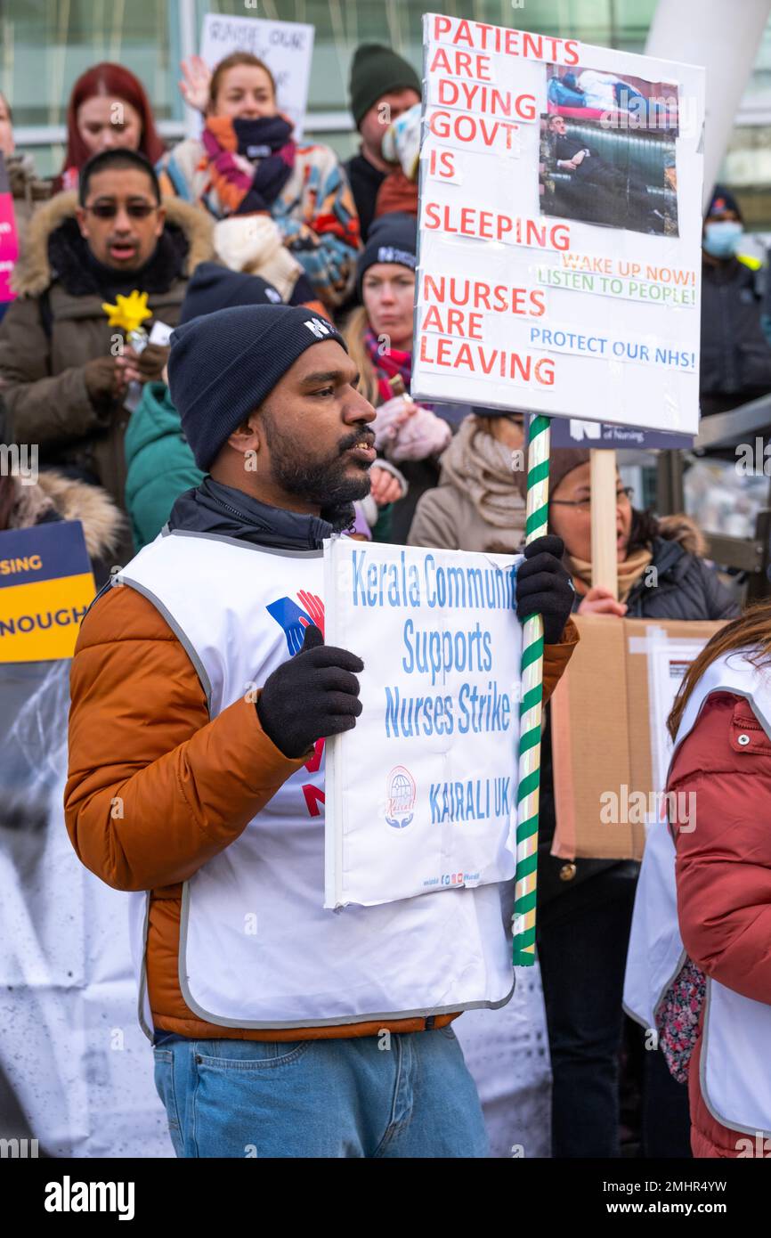 Striking nurses with placards, demonstrating outside University College ...