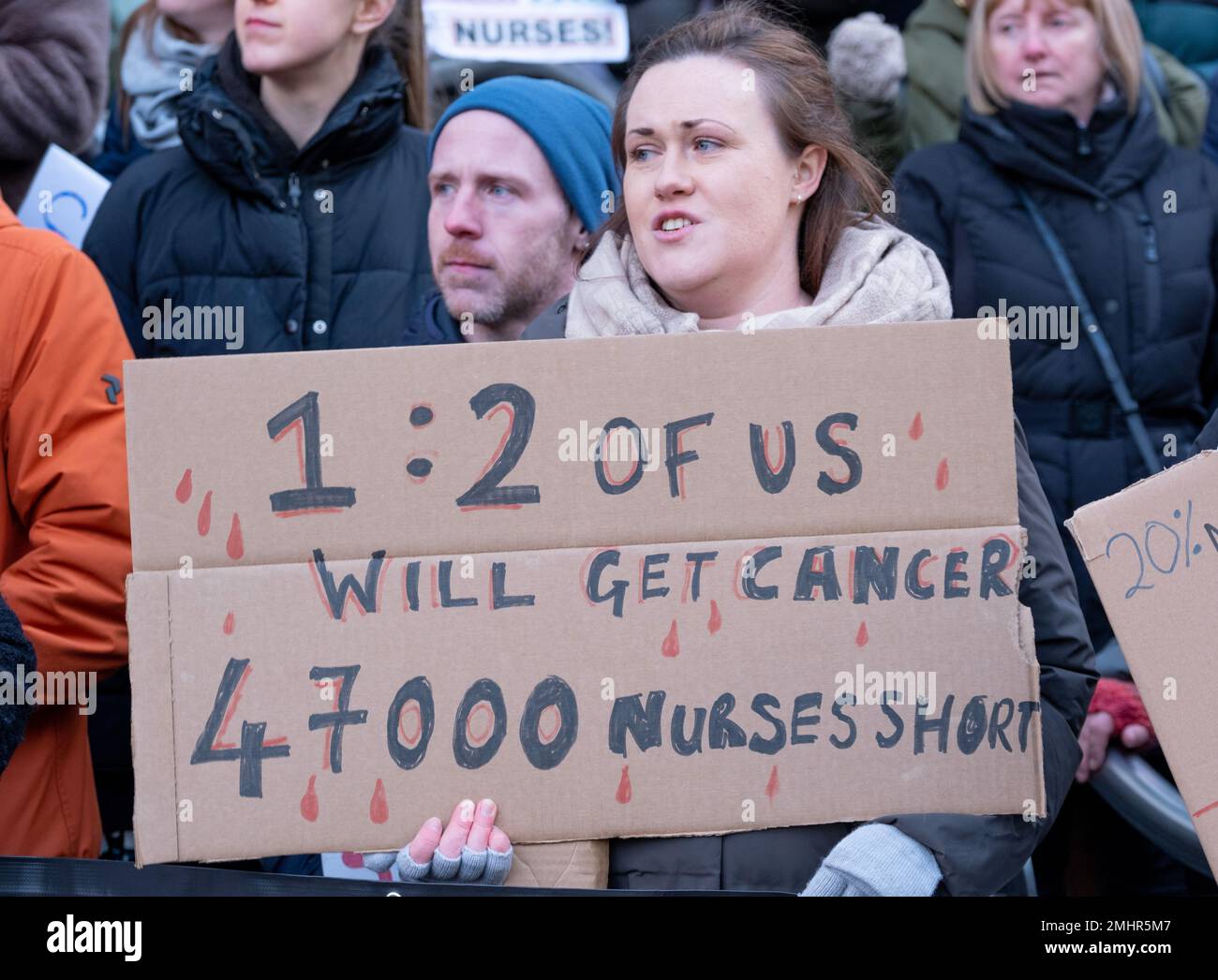 Striking nurses with placards, demonstrating outside University College ...