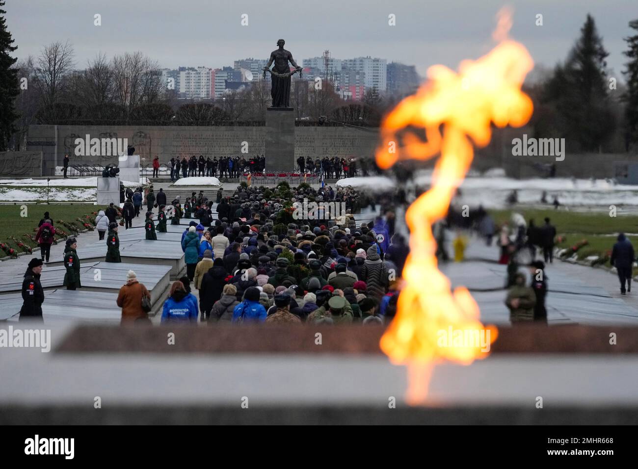 People walk to the Motherland monument to place flowers and wreaths at ...