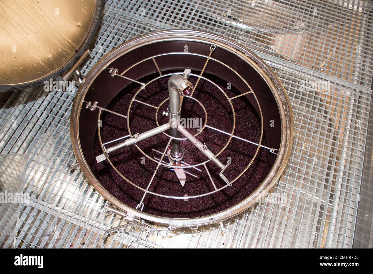 Modern aluminum barrels winery machine with red grapes Stock Photo - Alamy