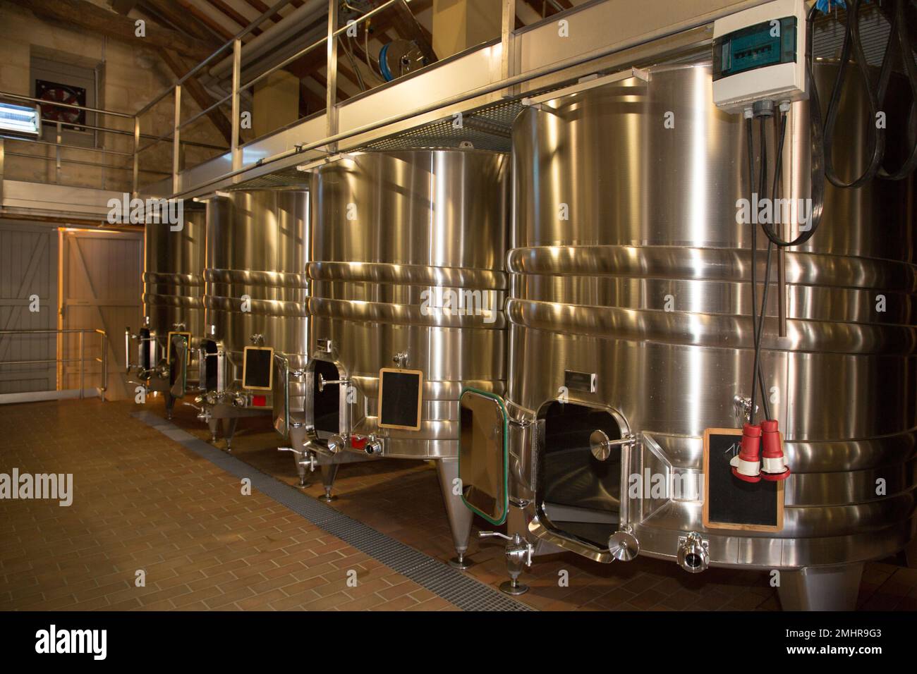 cellar with modern metal tanks in winery wine barrels rows Stock Photo ...